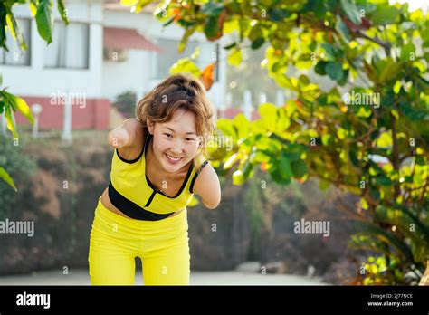 Happy Asian Armless Woman Warming Up Before Swimming At The Tropical