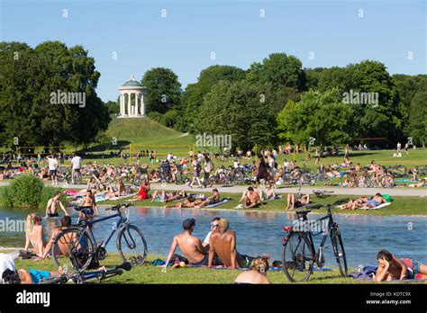 People Enjoying The Summer Day In Englischer Garten City Park In Munich
