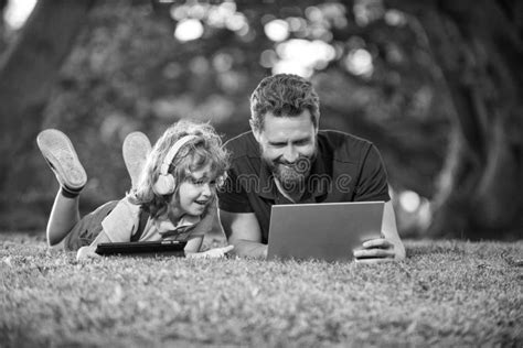 Dad And Son Use Laptop For Video Call Or Lesson Listen Music In