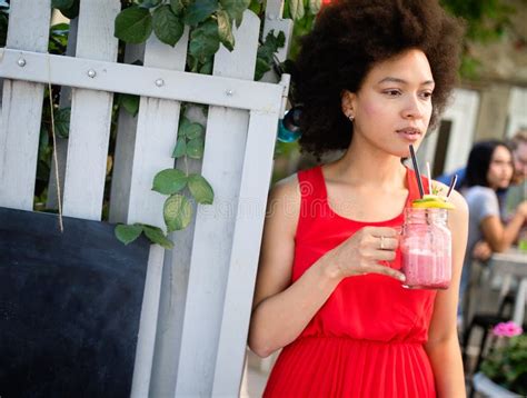 Beautiful Happy Black Woman Drinking Healthy Drink And Smiling Stock
