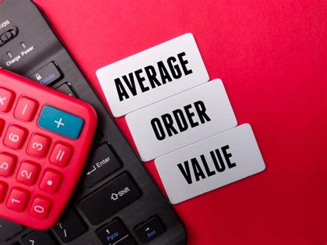Premium Photo Black Keyboard And Calculator With The Word Average Order Value On A Red Background
