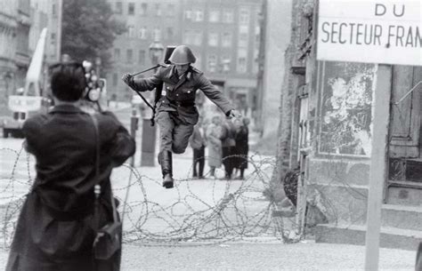 East Germany Soldier Hans Conrad Schumann Flees Over The Barbed Wire Border To West Germany