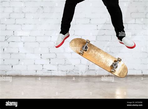 Skateboarder Performing Skateboard Trick Kick Flip On Concrete
