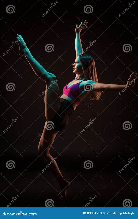 Young Beautiful Dancer In Beige Dress Dancing On Black Background Stock