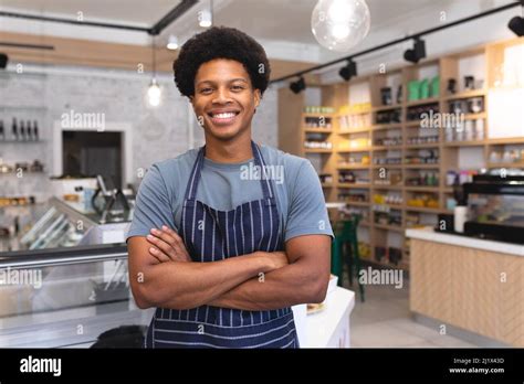 Portrait Of Smiling African American Young Male Barista With Arms