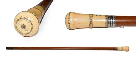 Lot 204 A Ivory And Pique Mounted Malacca Walking