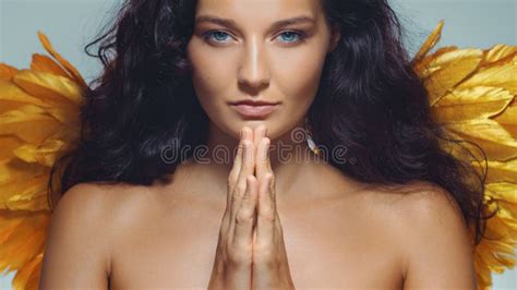 Focused Angel Woman With Golden Wings In Spiritual Beauty Close Up Shot