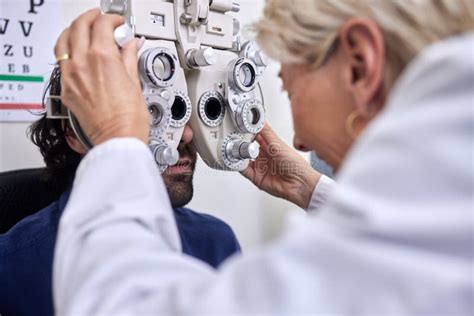 Doctor With Customer In Vision Test Or Eye Exam For Eyesight By Doctor