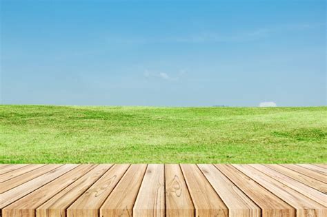 Premium Photo Wood Plank On Natural Green Grass Field And Sky Background
