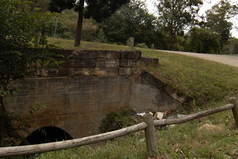 Years Of Water Flow Collapsing Grey Dam Concrete Overflow Pipes