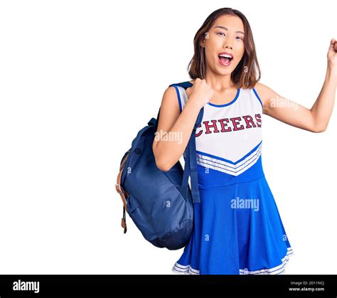 Young Beautiful Chinese Girl Wearing Cheerleader Uniform Holding