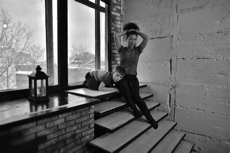 Premium Photo Mother And Son Sitting On Steps At Home