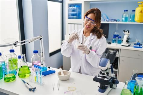 Premium Photo Young Latin Woman Wearing Scientist Uniform Working At