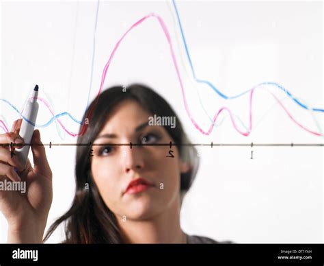 A Young Woman Drawing Coloured Graph Lines Across A Graph Illustration On A See Through Surface
