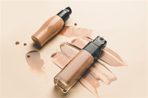 Bottles Of Makeup Foundation And Samples On Color Background Stock