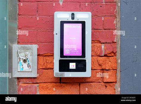 A Usps Key Keeper Box Next To A Butterflymx Smart Intercom System For