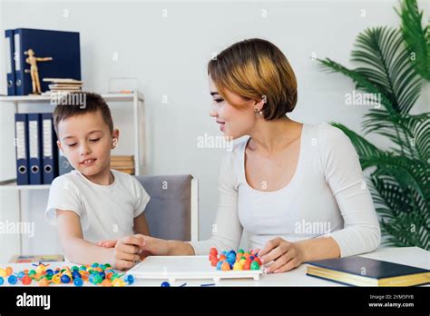 The Teacher Conducts Educational Games With A Constructor At The Table