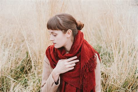 Portrait Of A Woman Wearing Bright Red Scarf By Stocksy Contributor