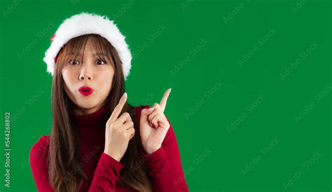 Young Asian Woman In Red Sweatshirt Wearing Santa Hat Finger Pointing