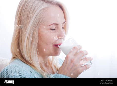 Happy Middle Aged Woman Drinking Milk Stock Photo Alamy