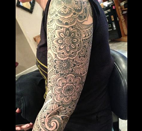 A Woman With A Tattoo On Her Arm
