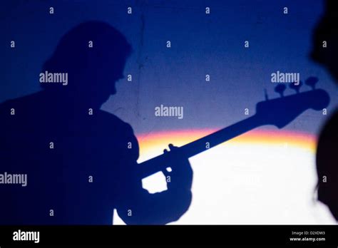 Silhouette Of A Bass Player David Goodier Of Jethro Tull Playing His