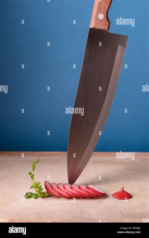 Fresh Sliced Radish On Cutting Board Knife Close Up Blue Background