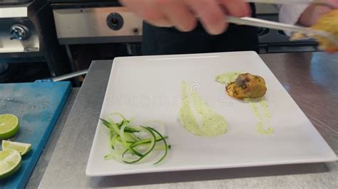 Plating Of A Raw And Cooked Fish Based Appetizer In A Luxury Italian