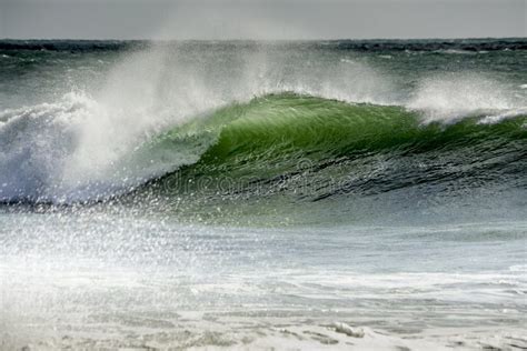 Waves Crash On To The Rocks And Beaches Of A Cornish Coastline Stock