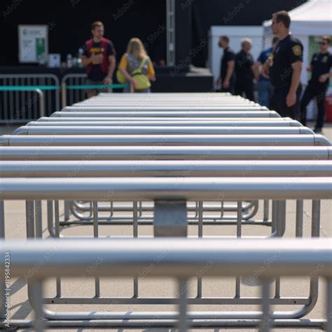Security Personnel Monitoring A Crowded Outdoor Event With Focus On Visible Crowd Control