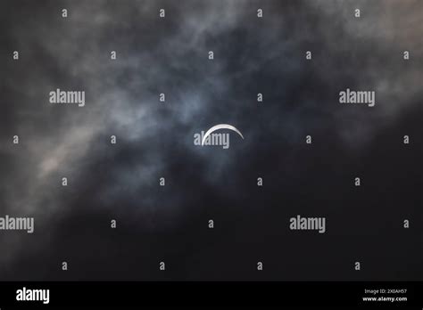 Partial Solar Eclipse Moon Covers Sun Dark Clouds Celestial Drama