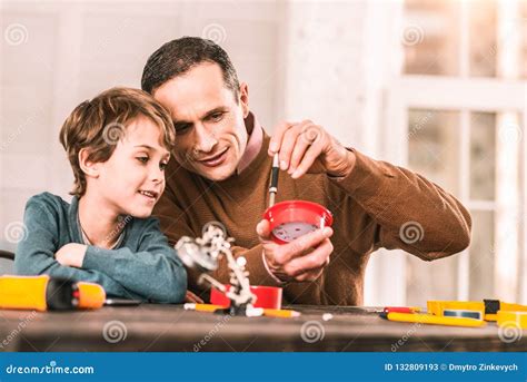 Genius Father Demonstrating The Wonders Of His Collection Of Instruments Stock Image Image Of