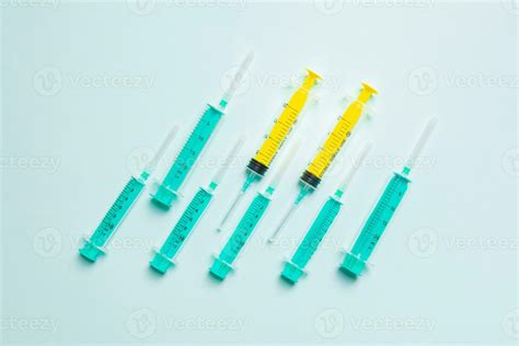 Top View Of Medical Syringes With Needles At Blue Background With Copy