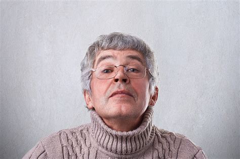 A Closeup Of Funny Grandfather In Glasses Looking Happily Through