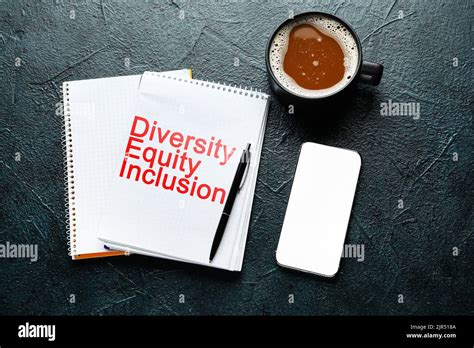 notebooks with text diversity equity inclusion pen mobile phone and