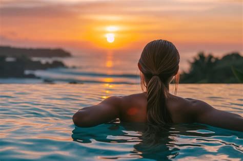 Premium Photo Woman Relaxes In An Infinity Pool Gazing At The Ocean