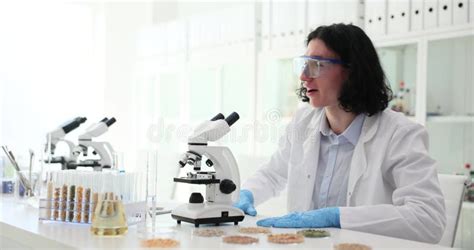 Worker Carefully Examines Genetically Modified Germs Of Grains And