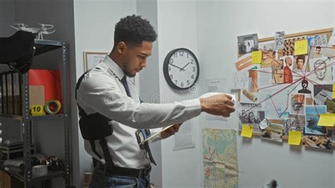A Professional African American Man At A Detective S Office Examining