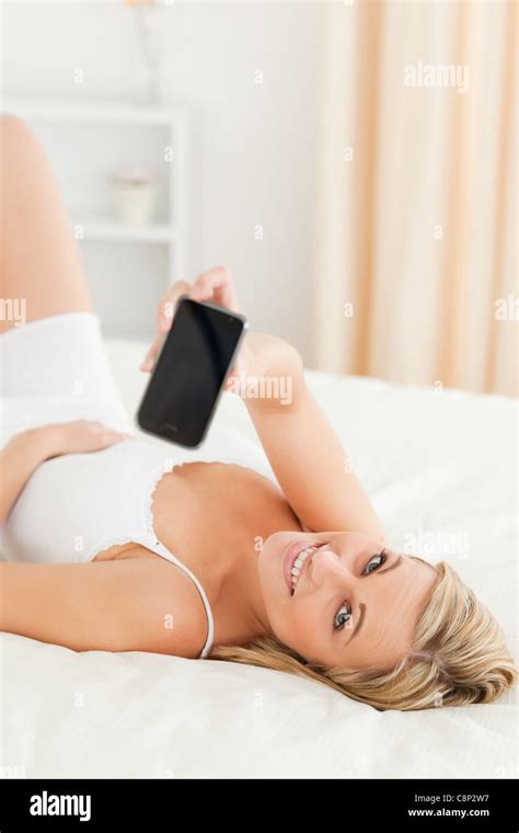 Portrait Of A Blonde Woman Showing Her Phone Stock Photo Alamy