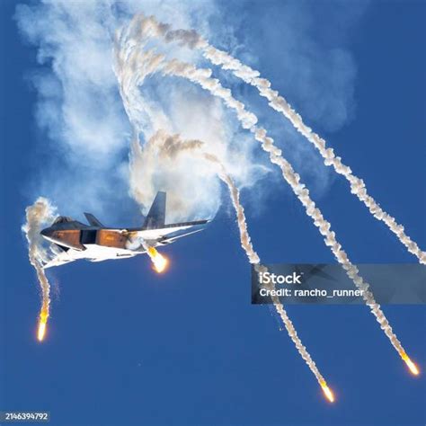 Epic Frontal View Of A F22 Raptor Deploying Flares In A Turn In Smoke And In Beautiful Light