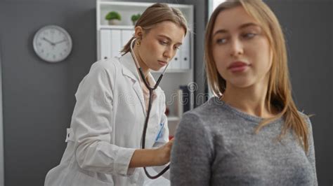 Doctor Examining Patient In Clinic With Two Women In A Medical Setting