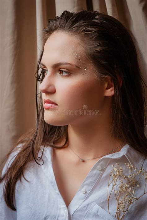Thoughtful Woman In White Shirt With Glitter Makeup And Dried Flowers Caucasian Woman With