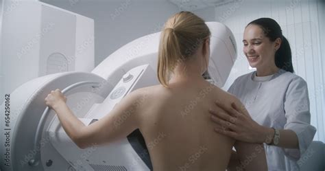 Hospital Radiology Room Caucasian Woman Stands During Mammography