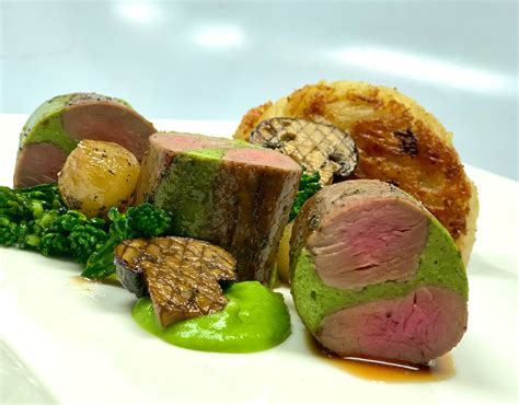 Roasted Australian Lamb Loin With Herb Inlay Seasonal Vegetables Potato Parmesan Gratin Glace
