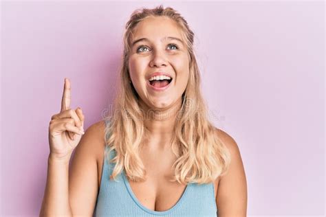 Young Blonde Girl Wearing Casual Clothes Pointing Finger Up With