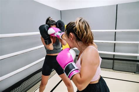 Female Boxer Punching Her Practice Opponent In The Stomach From The