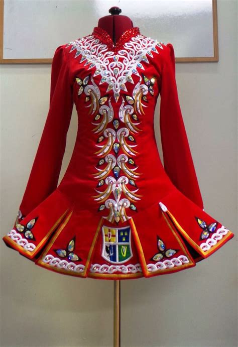 A Red And White Dress On Display In Front Of A Mirror