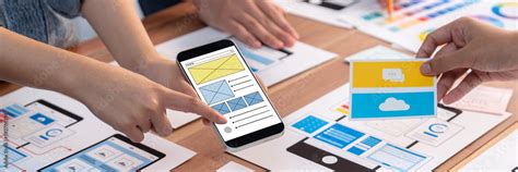 Panorama Shot Of Front End Developer Team Brainstorming UI And UX Designs For Mobile App On