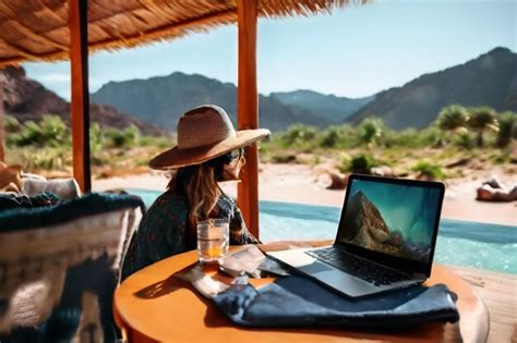 A Woman Sits At A Table With A Laptop And A Drink Premium Ai Generated Image