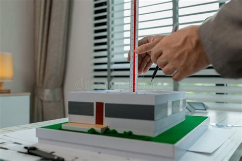 An Architect Works In The Office An Engineer Is Using A Tool To Take